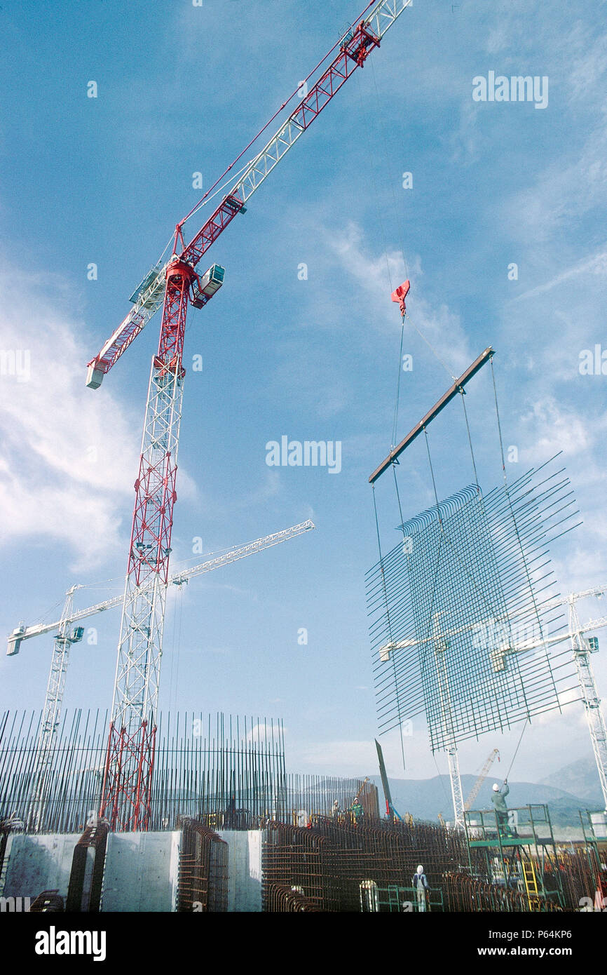 Tower crane lifting sheets of steel reinforcing mesh on the Rion ...