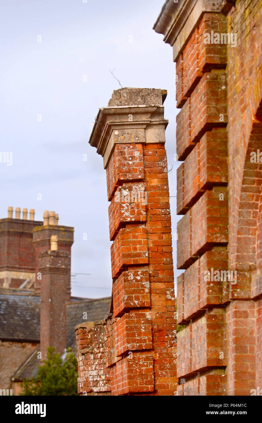 A old red brick gateway pillar in need of restoration to correct its ...