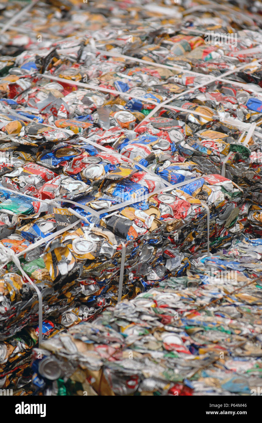 Crushed tin cans in bales at a metal recycling facility on the dockside ...