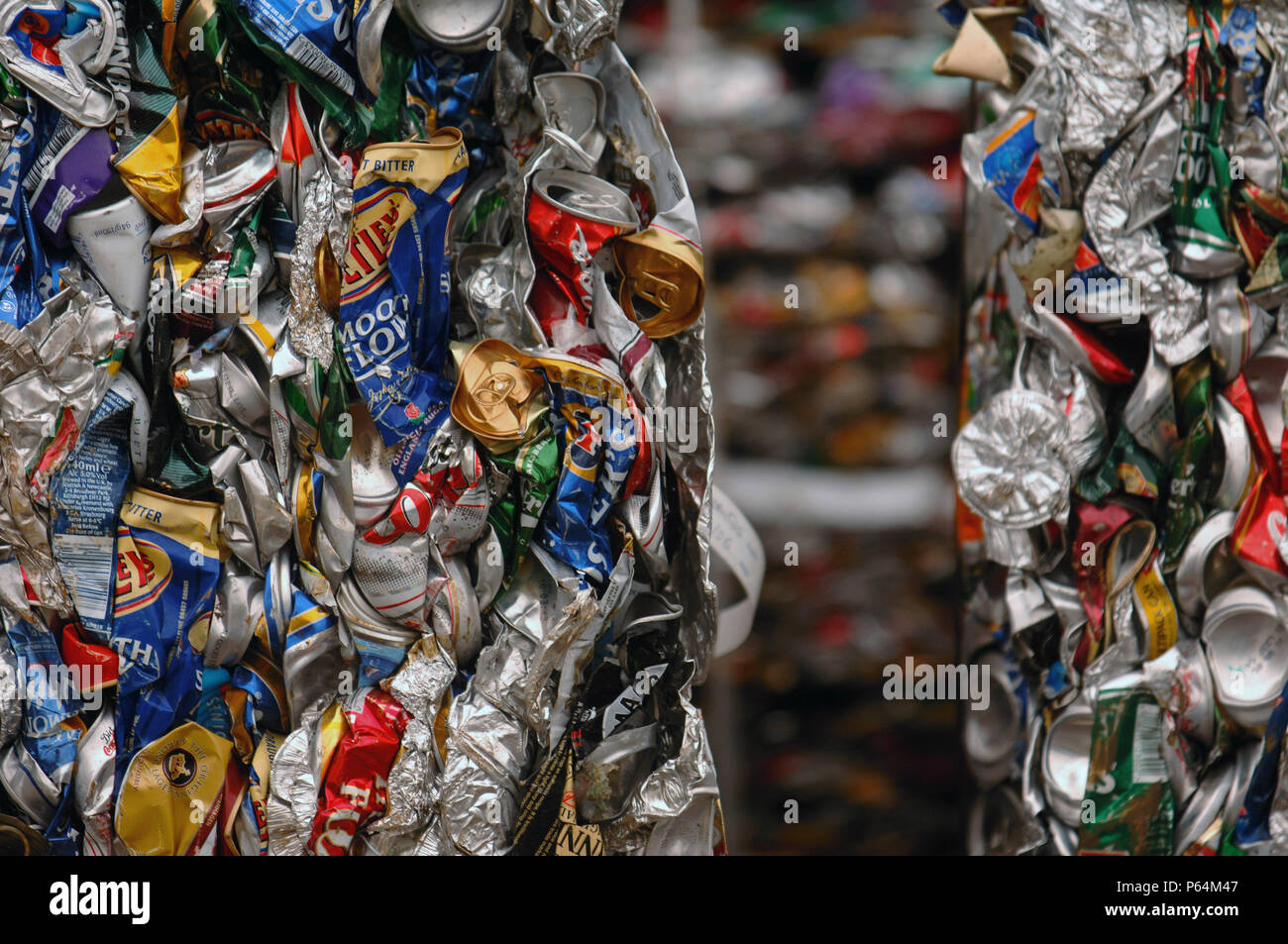 Crushed tin cans in bales at a metal recycling facility on the dockside ...