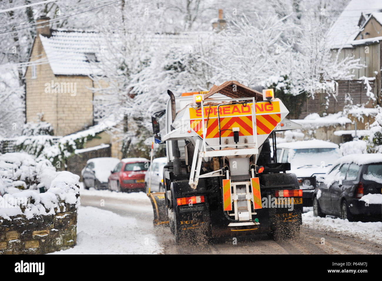 Snow plough and gritter in snowy weather, England, UK Stock Photo - Alamy
