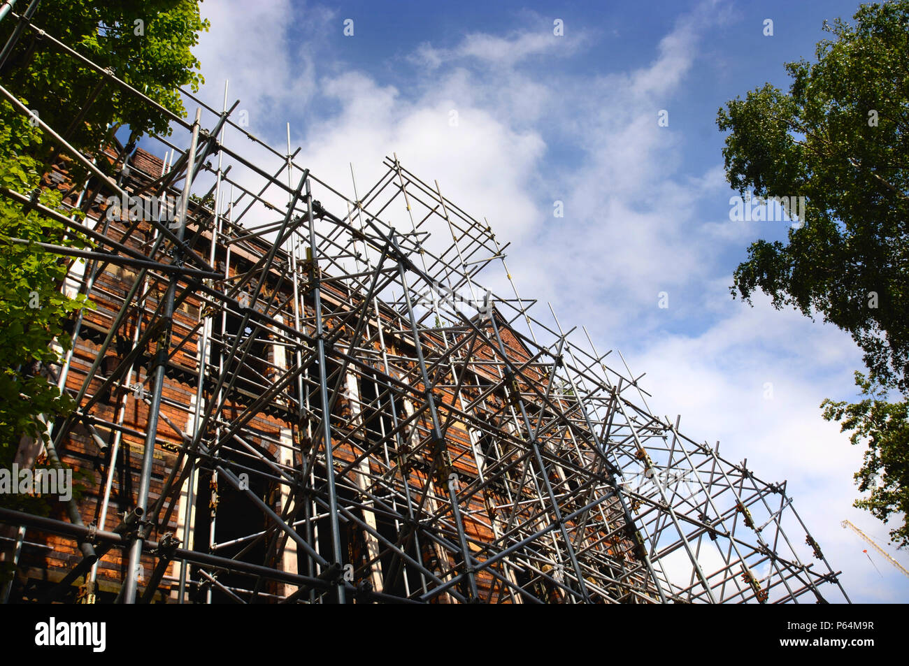 Victorian red brick building surrounded by scaffolding, Manchester, UK ...