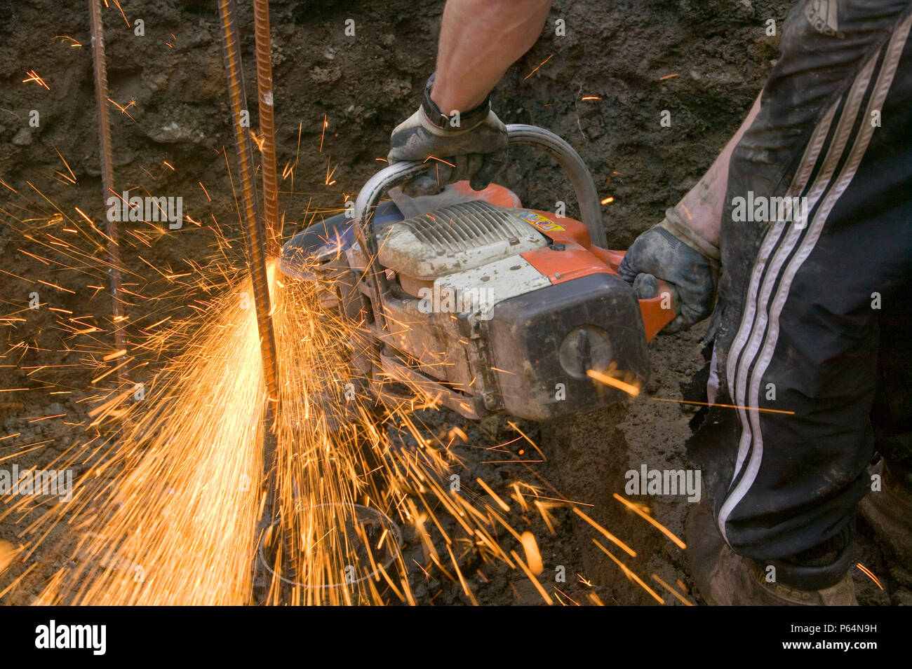 Builder using an angle grinder Stock Photo - Alamy