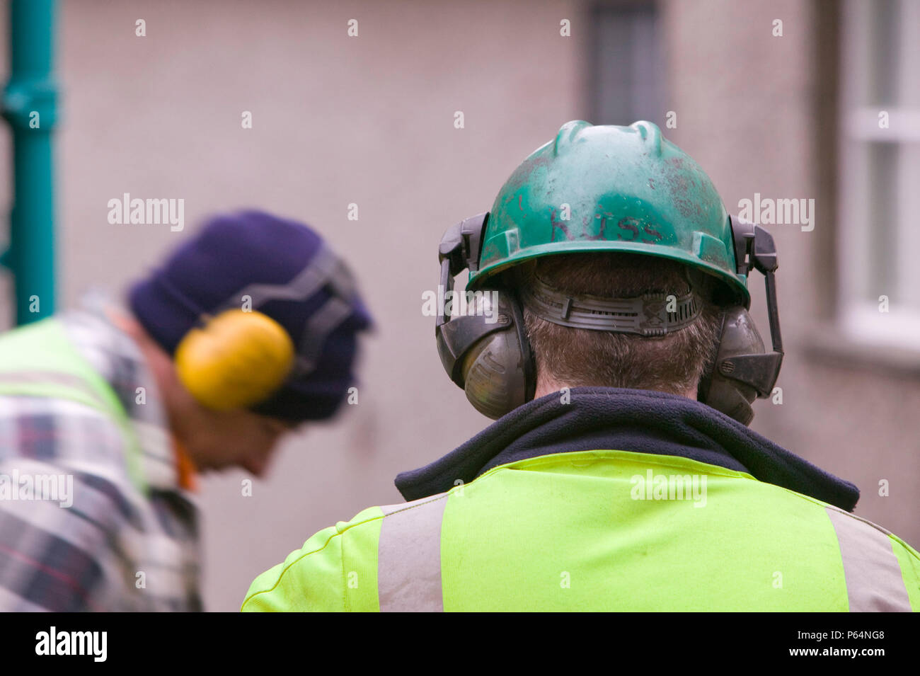 Workmen using ear protectors Stock Photo - Alamy