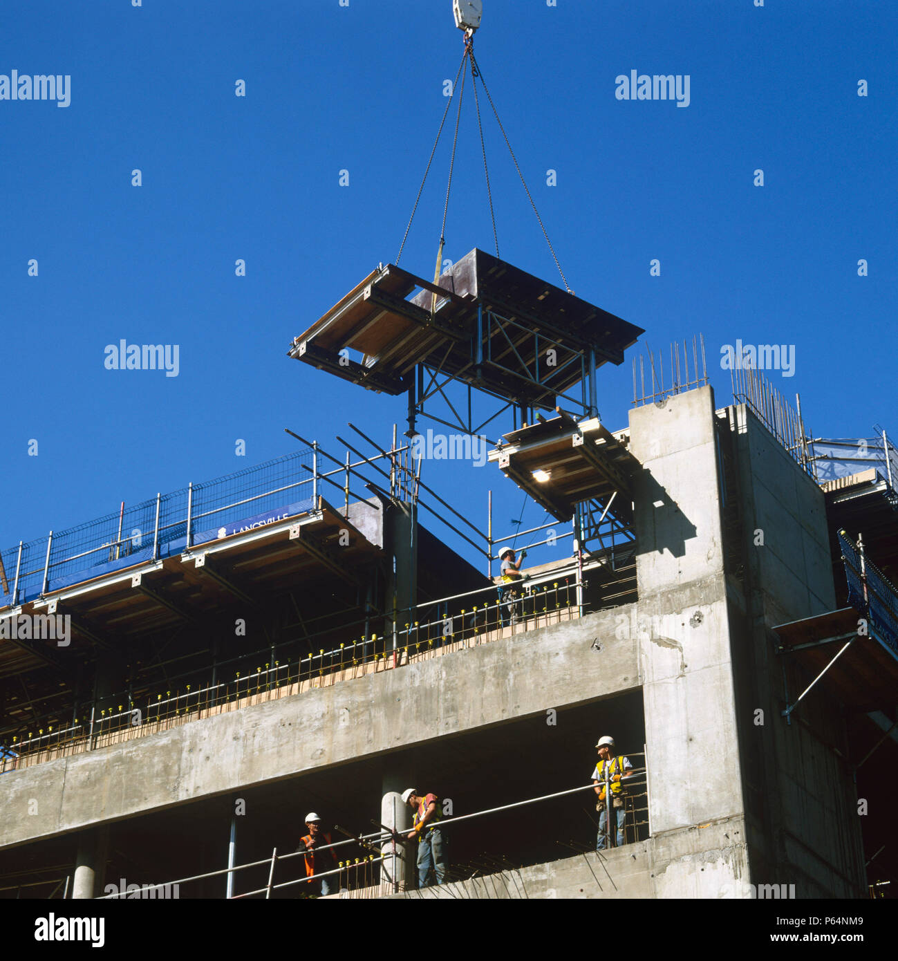 Crane delivery of material on a construction site Stock Photo - Alamy