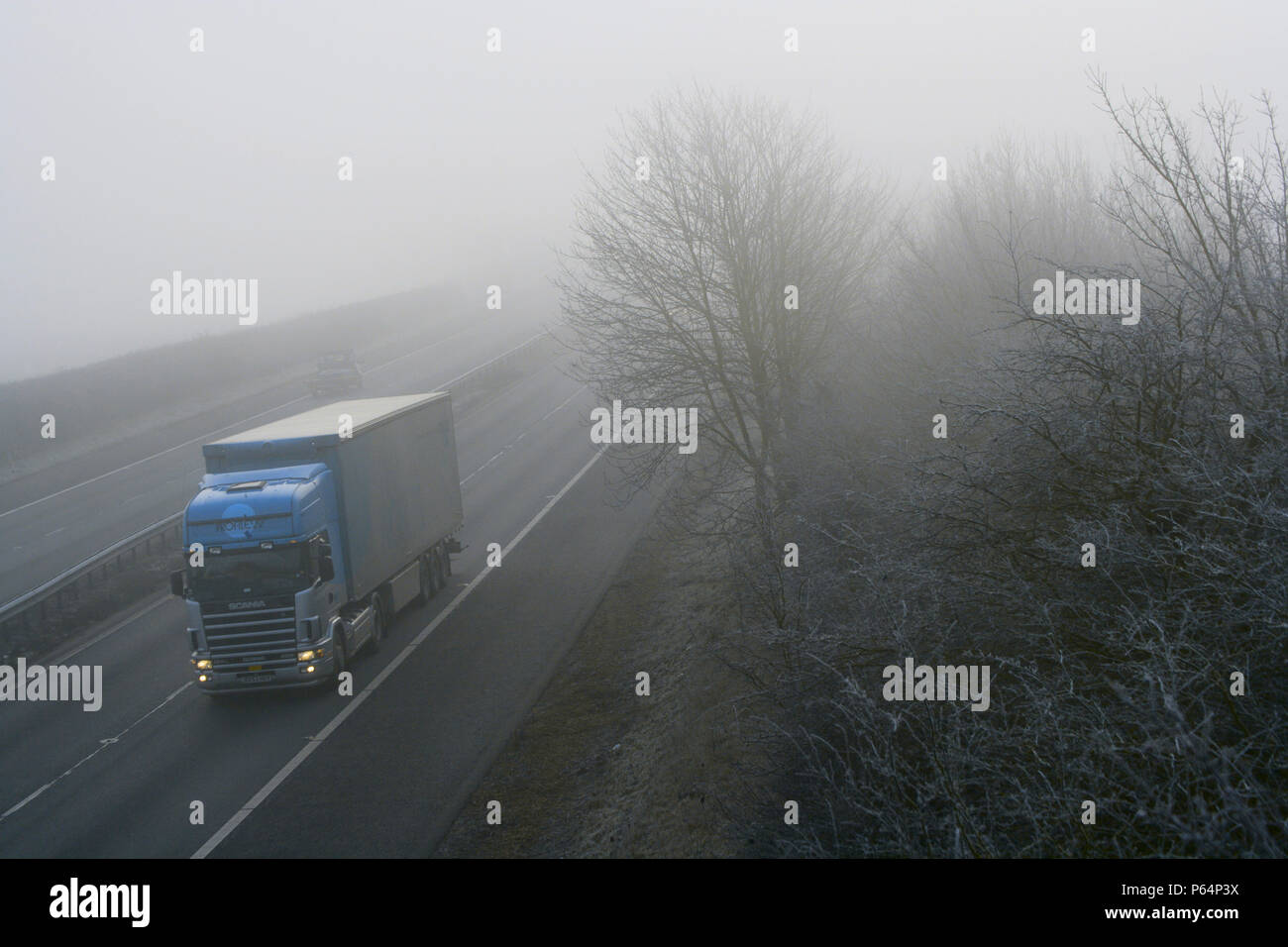 Traffic on motorway during winter with dangerous thick fog Stock Photo ...