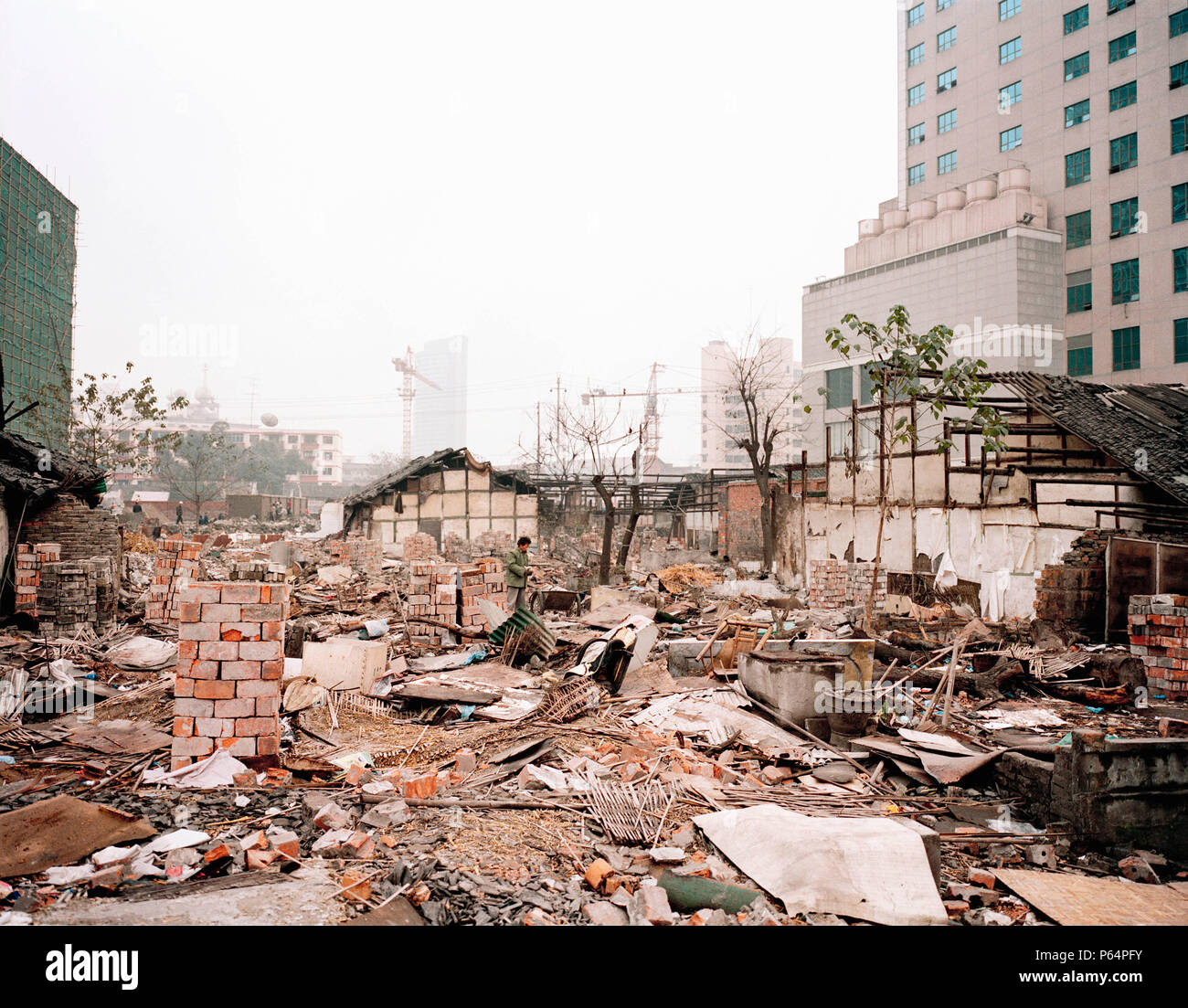 Migrant worker collecting scraps at demolition site, Chengdu, China ...
