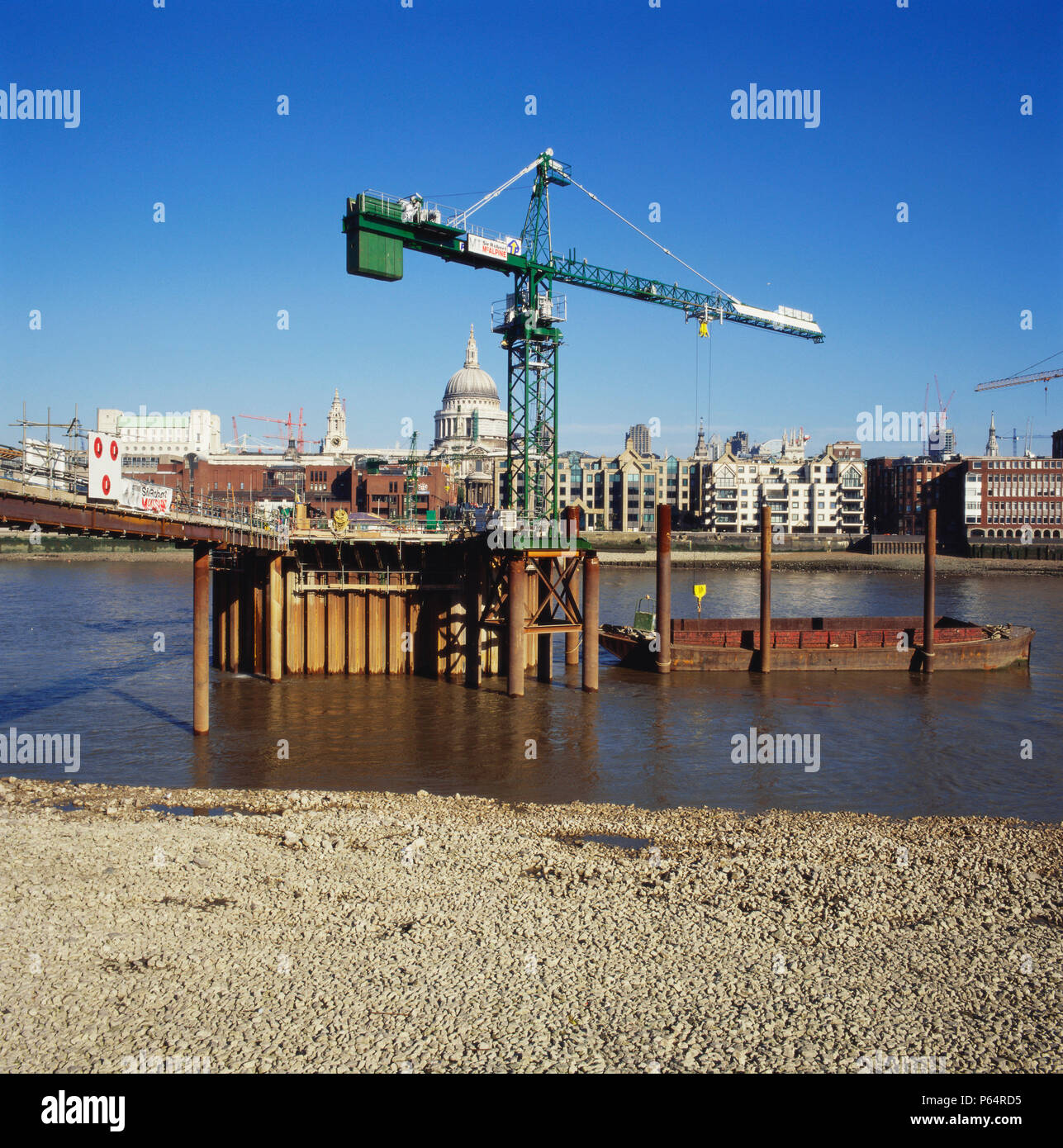 Crane unloading river barge on the Thames, London, UK Stock Photo - Alamy