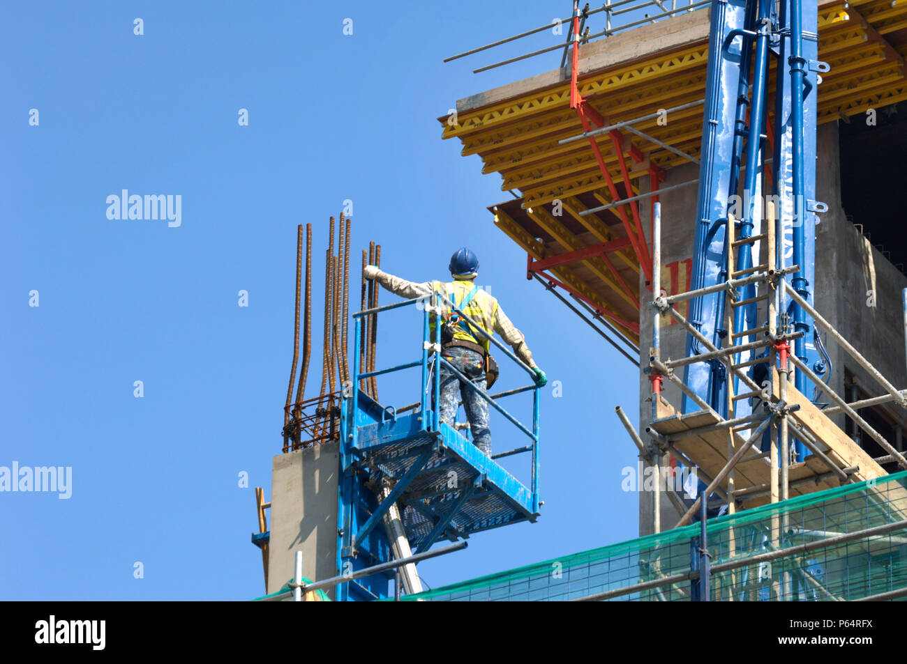 Construction worker working on platform, New Street Square, London, UK ...