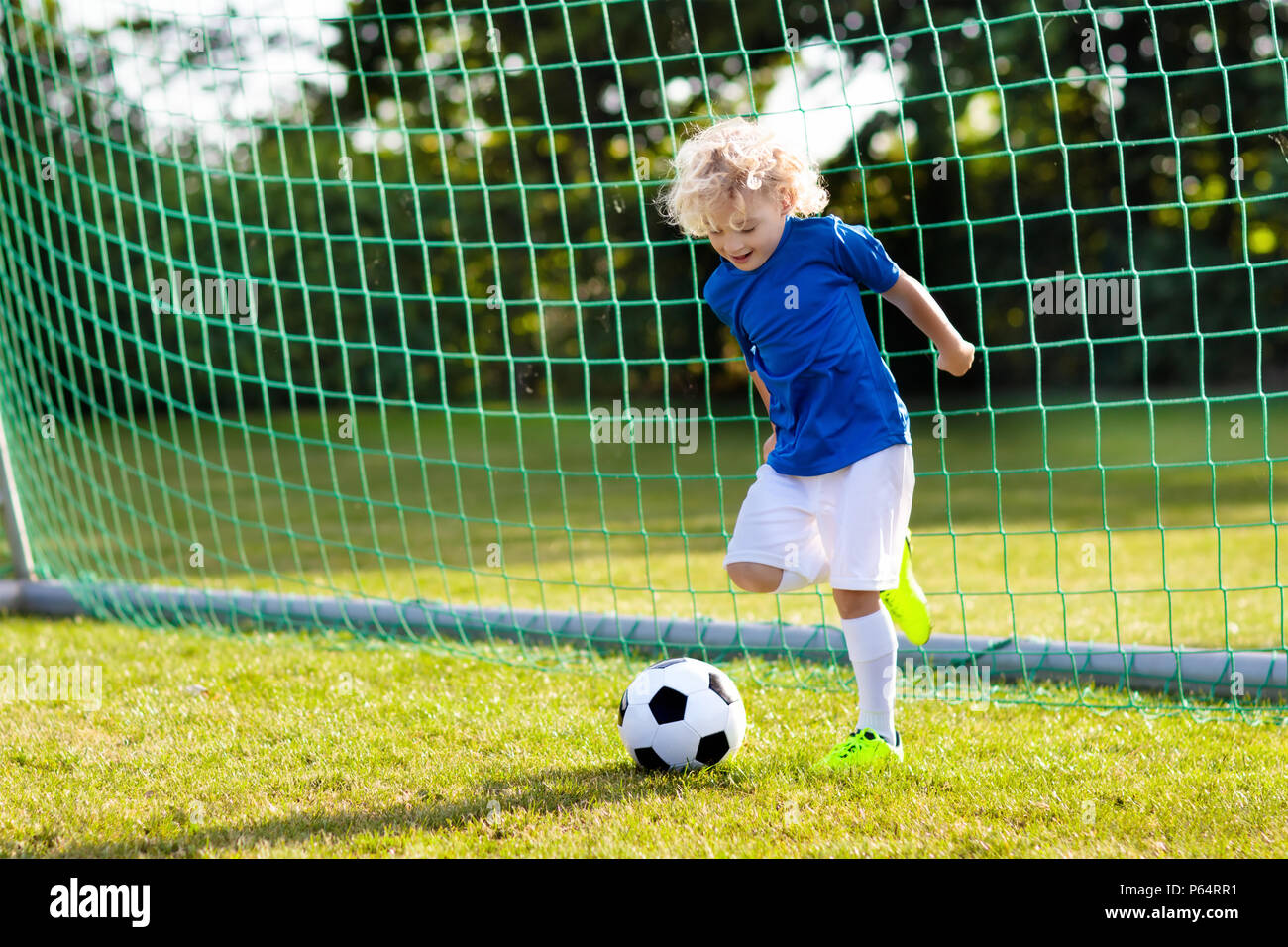 Child kicking foot ball hi-res stock photography and images - Alamy