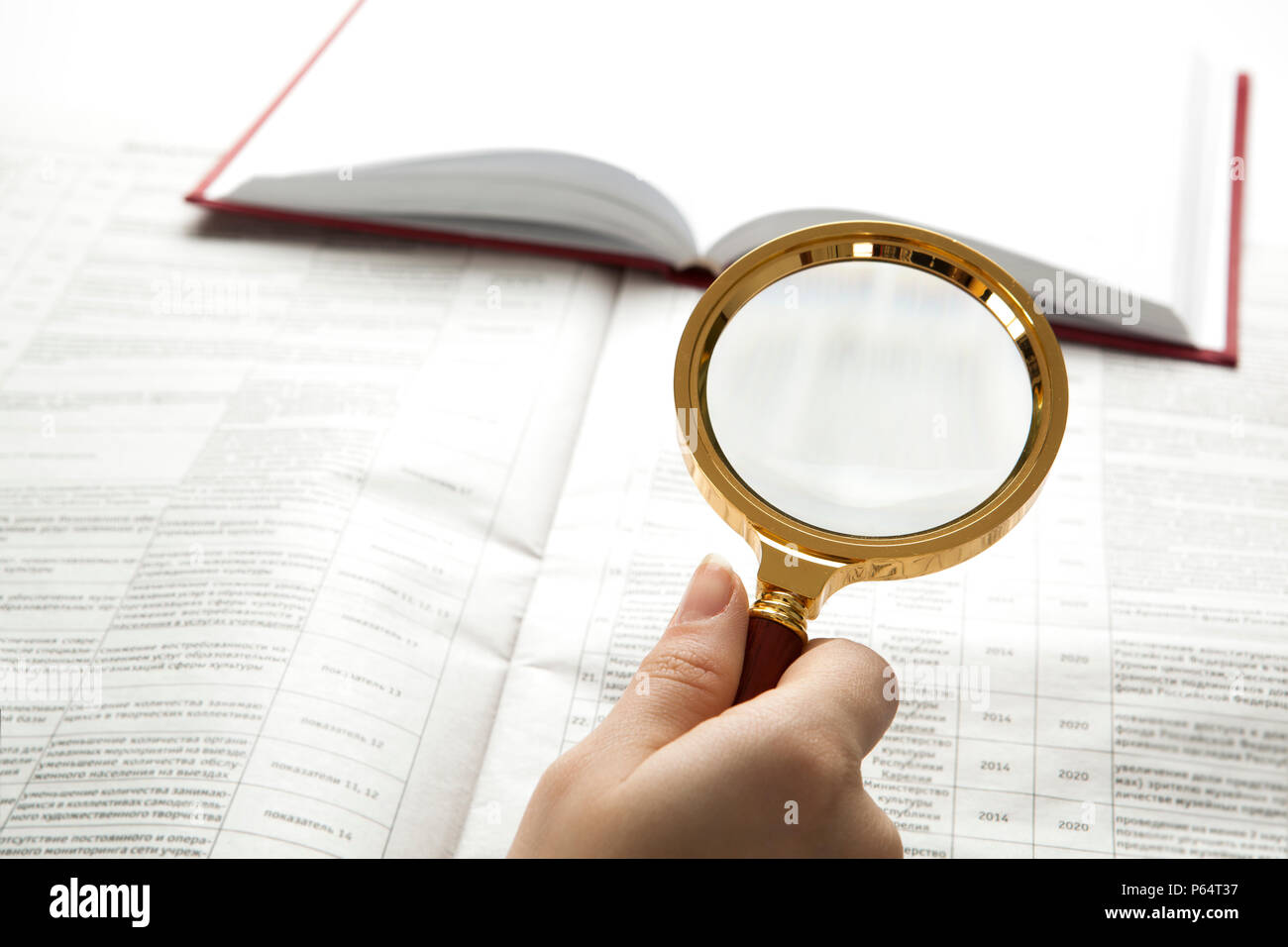 worker examines a magnifying glass text close up Stock Photo - Alamy