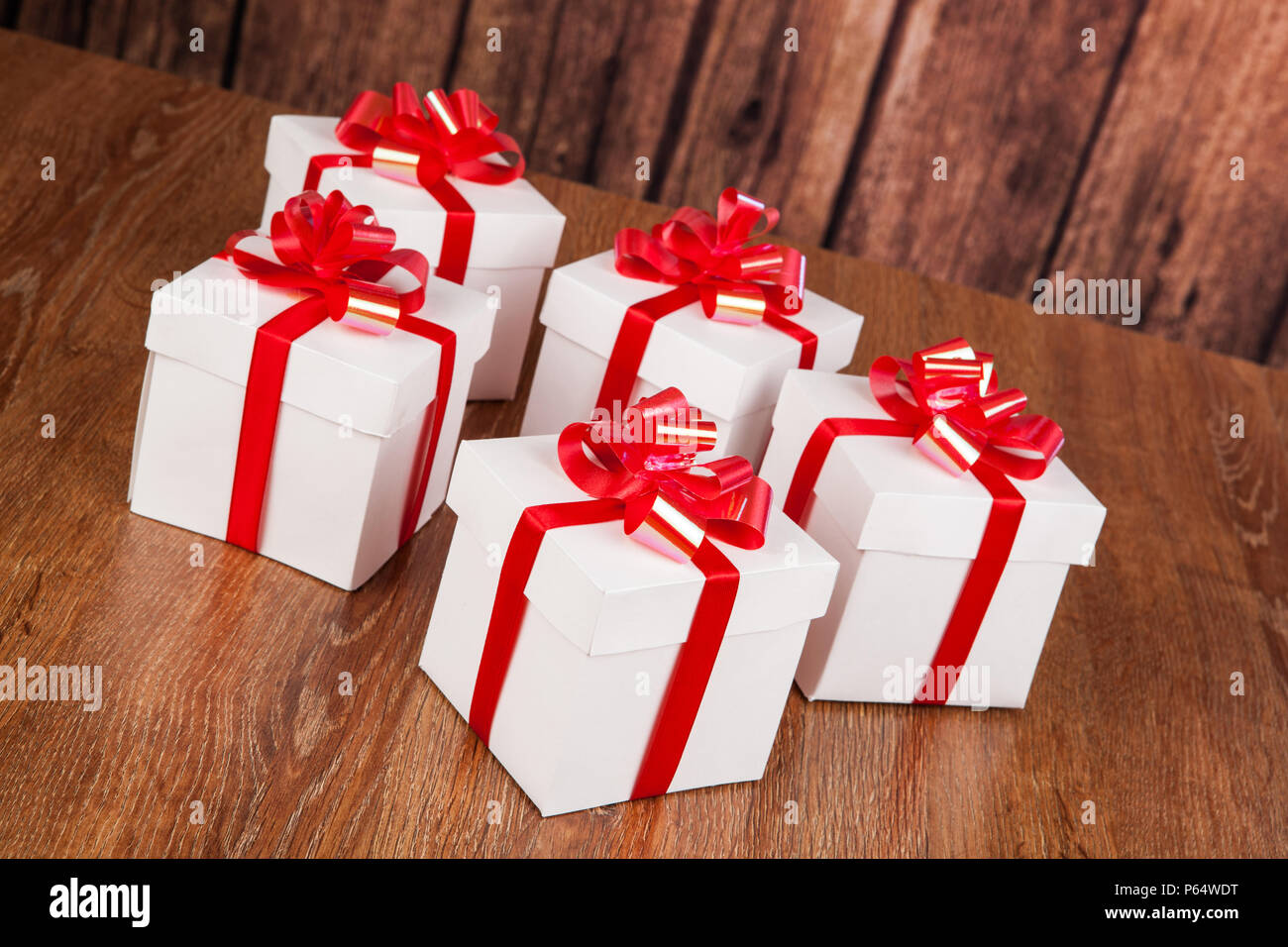 white gift boxes on a wood background Stock Photo - Alamy