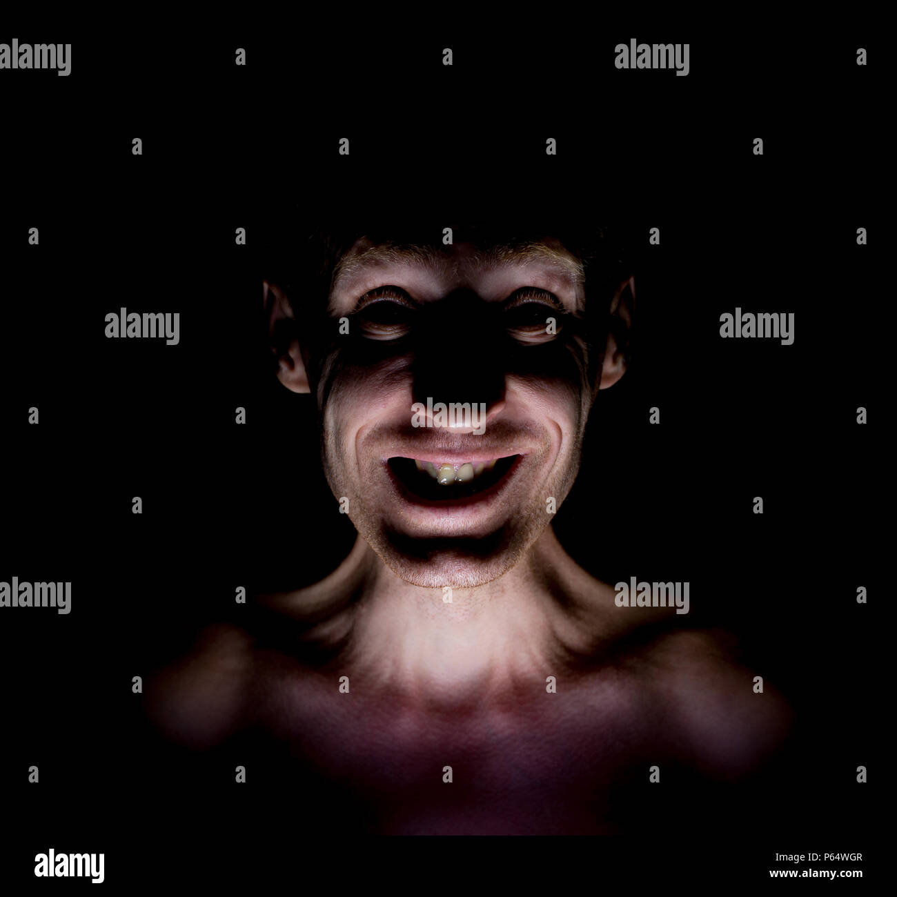 Stylish dark portrait of caucasian man who smiles like a mad or maniac ...