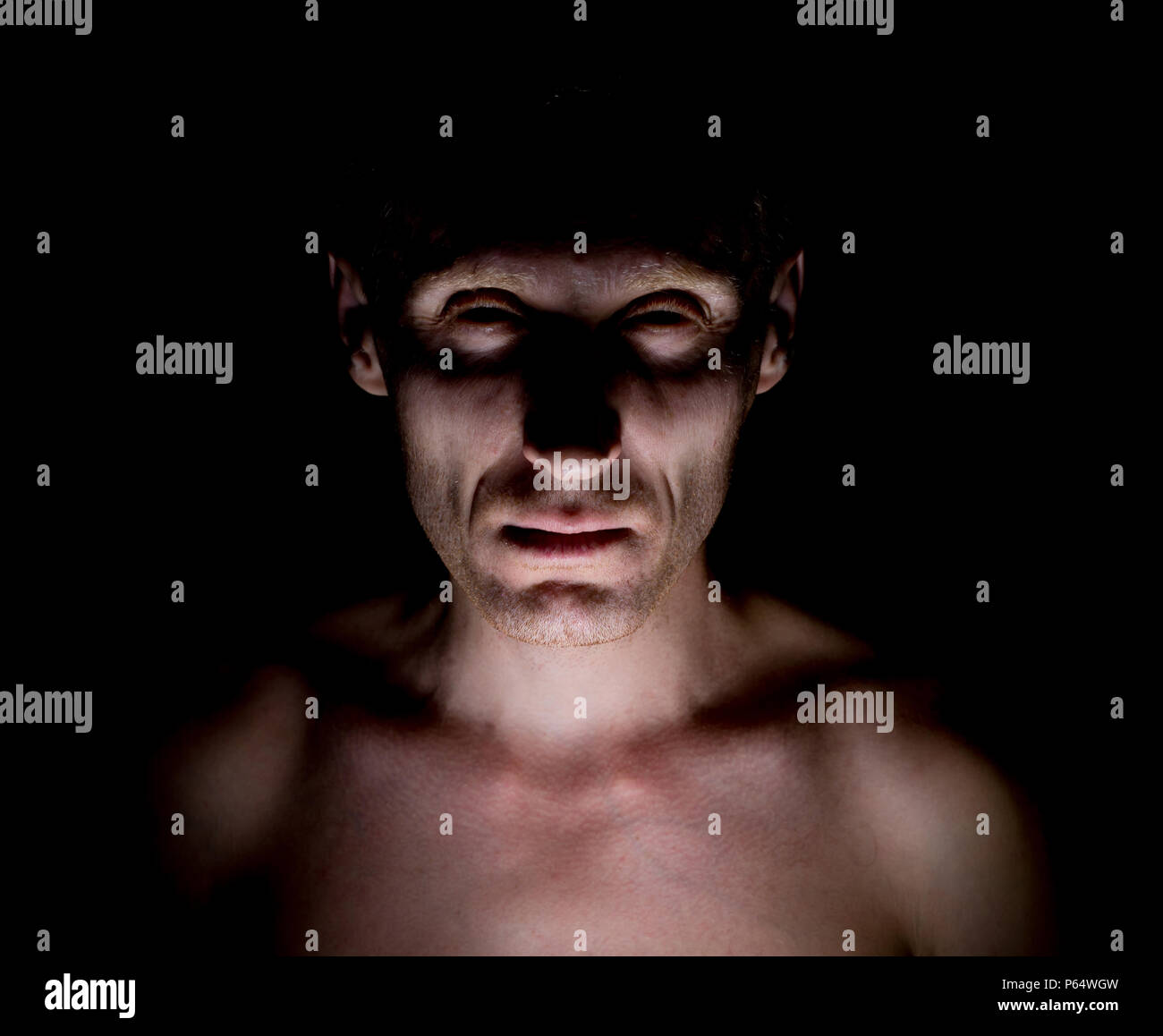 Stylish dark portrait of caucasian man who looks straight at you and ...