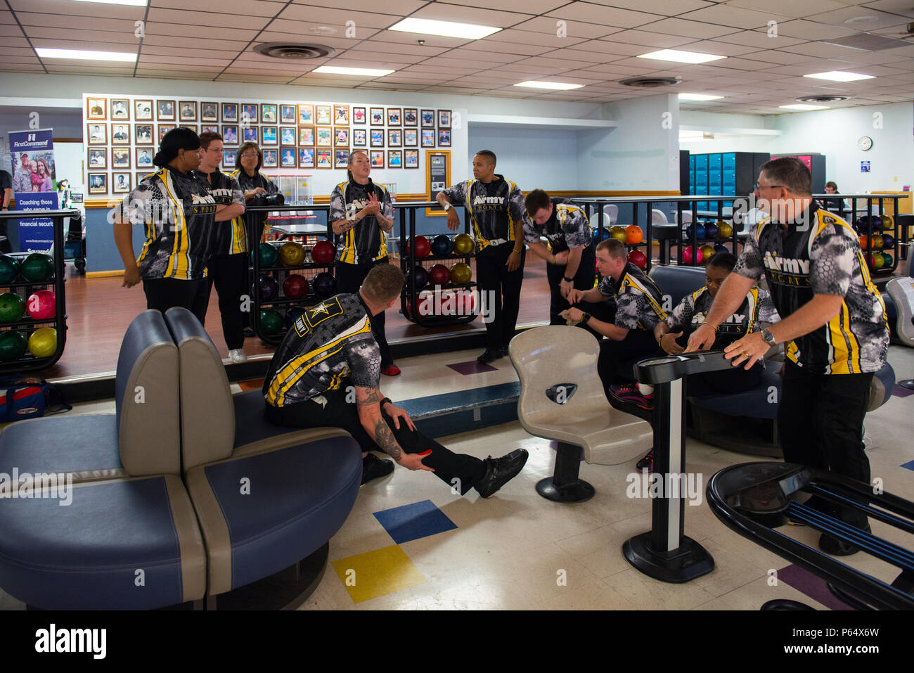 Members of the U.S. Army bowling team receive instructions before ...