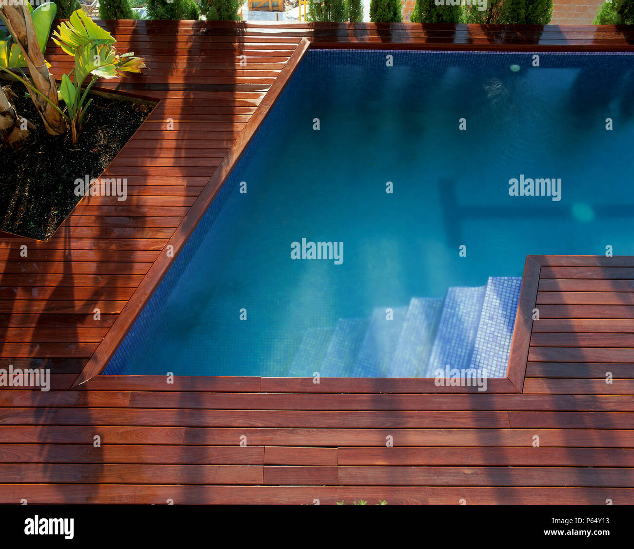 Partial view of a swimming pool with a wooden deck Stock Photo - Alamy