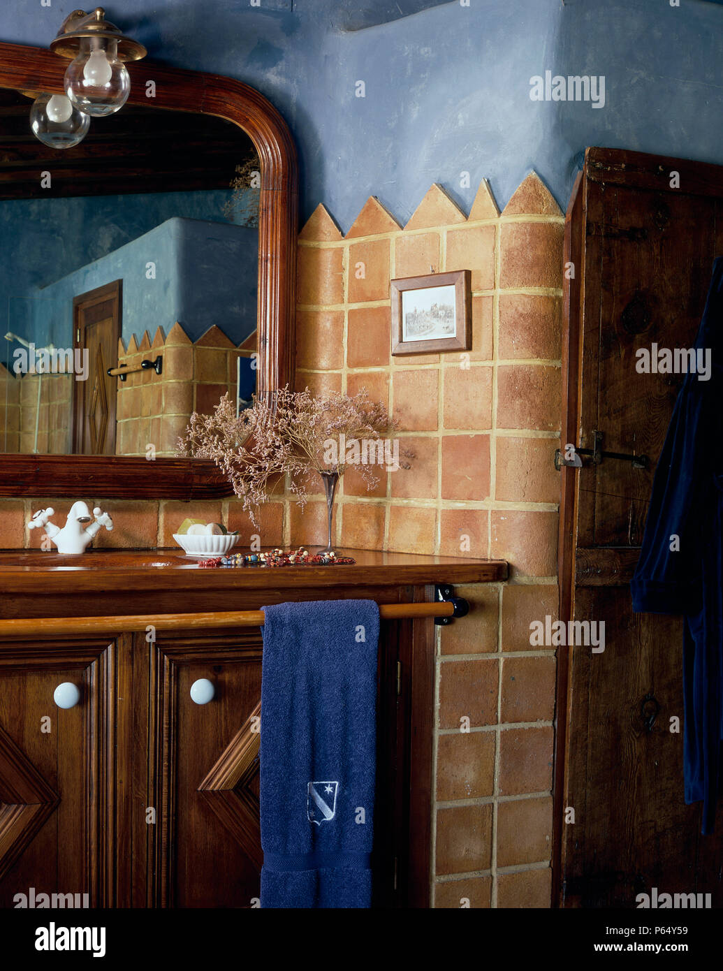 View of a cabinet below a mirror in the bathroom Stock Photo - Alamy