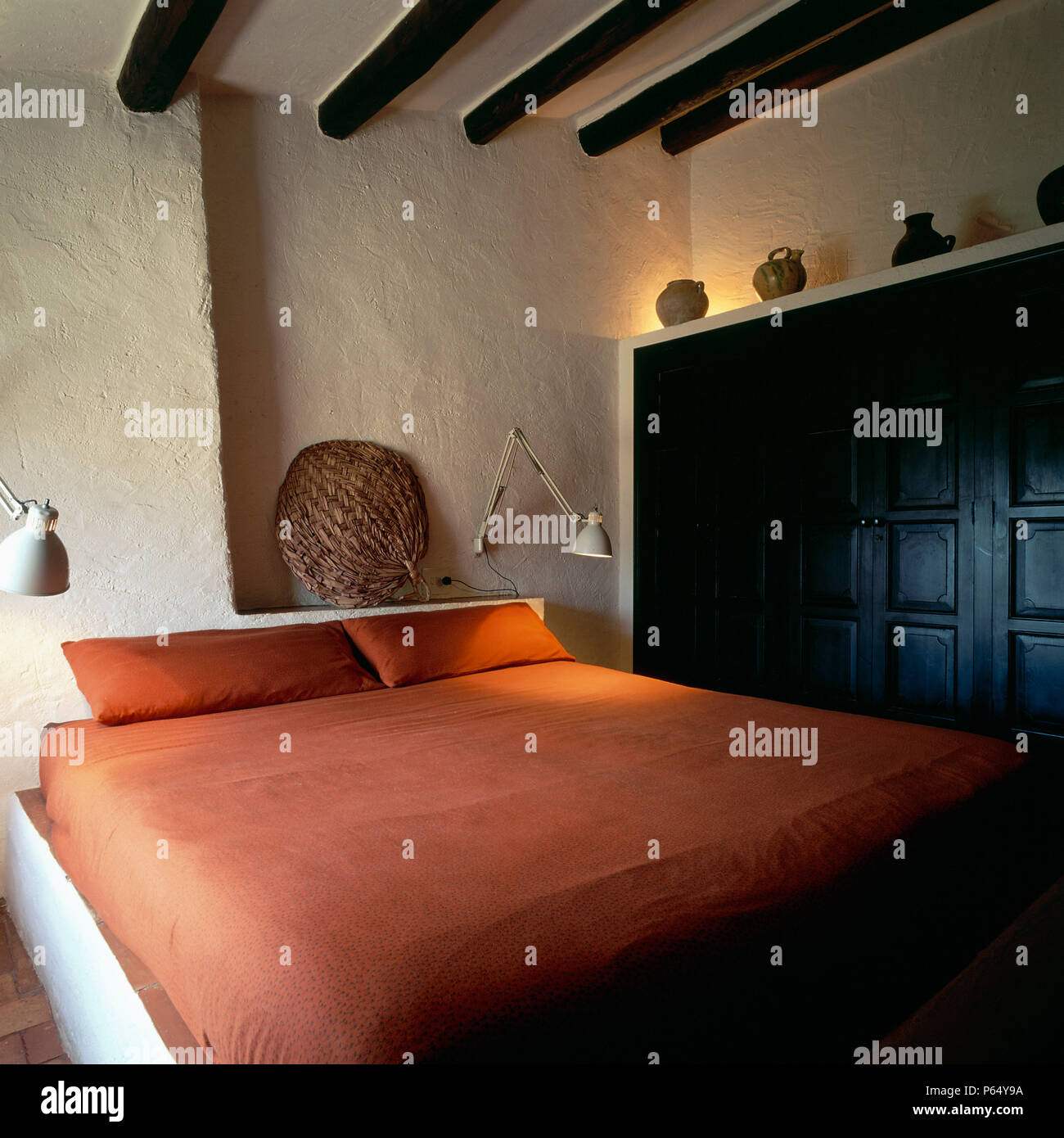 View of a cozy bed in a bedroom Stock Photo - Alamy