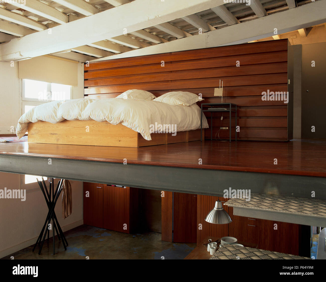 View of a cozy bed in an eclectic bedroom Stock Photo - Alamy