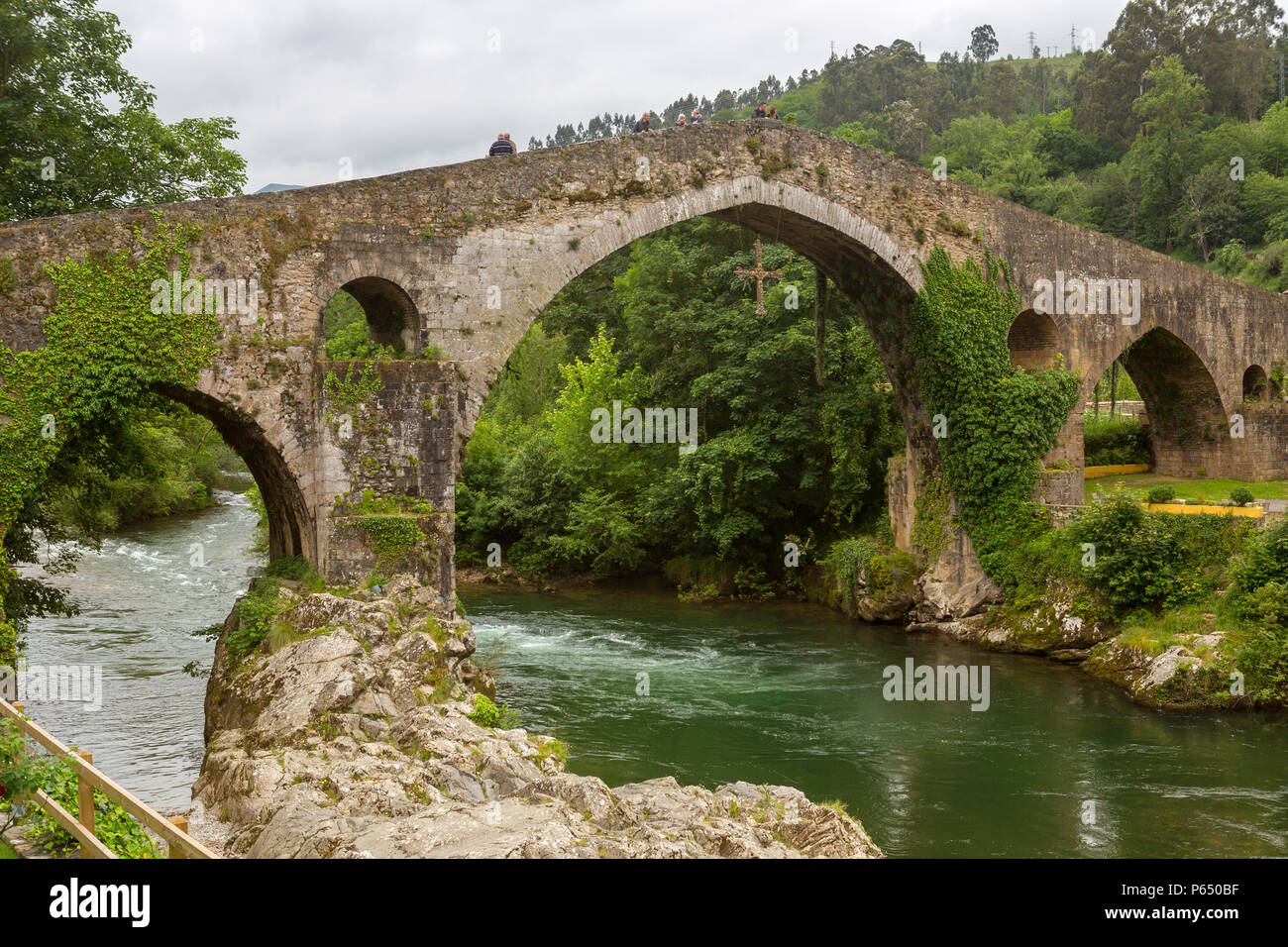 Cangas de Onis, Spain - May 31, 2018: People at the Roman bridge built ...