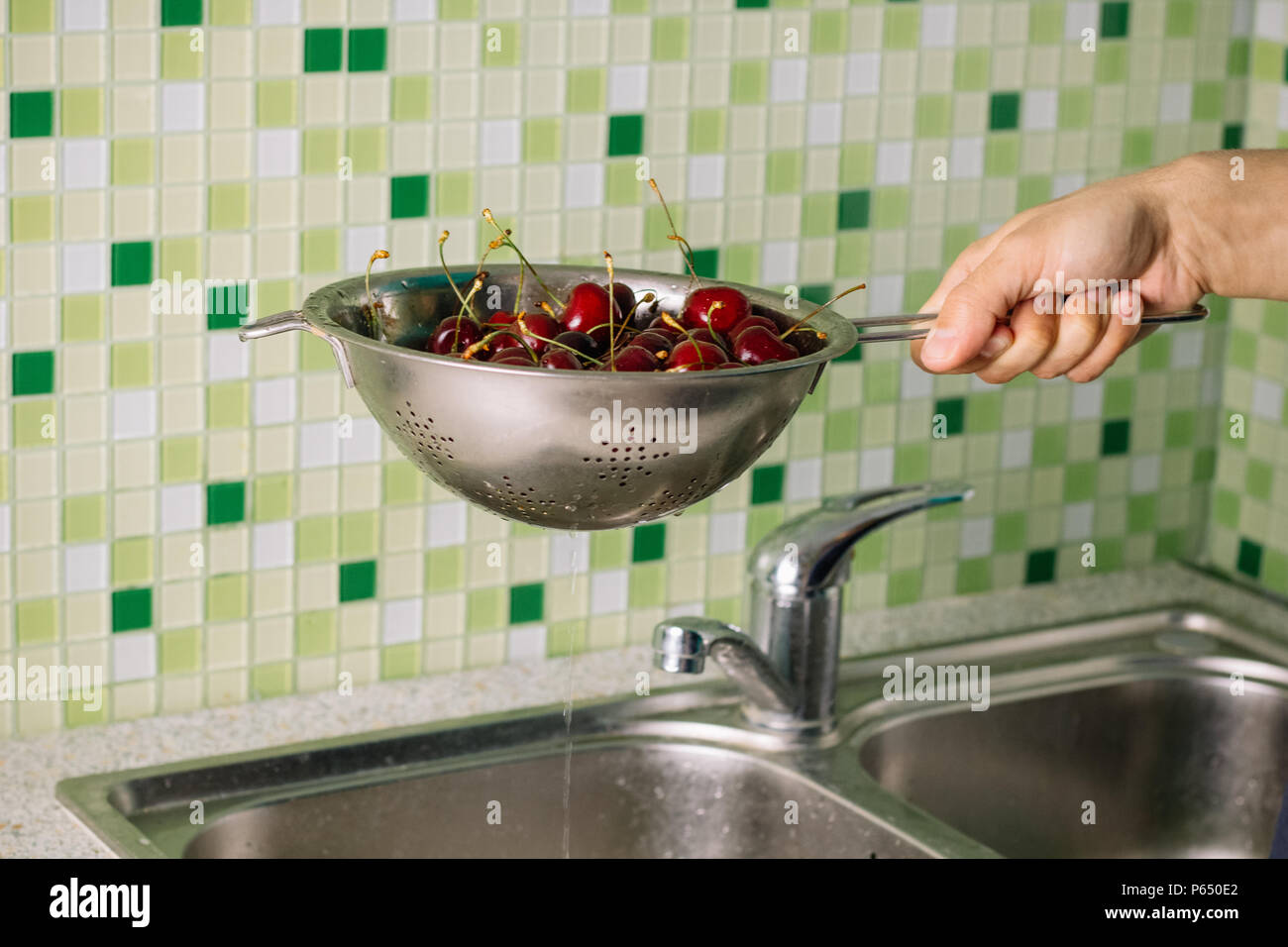 washing cherries before eating Stock Photo - Alamy