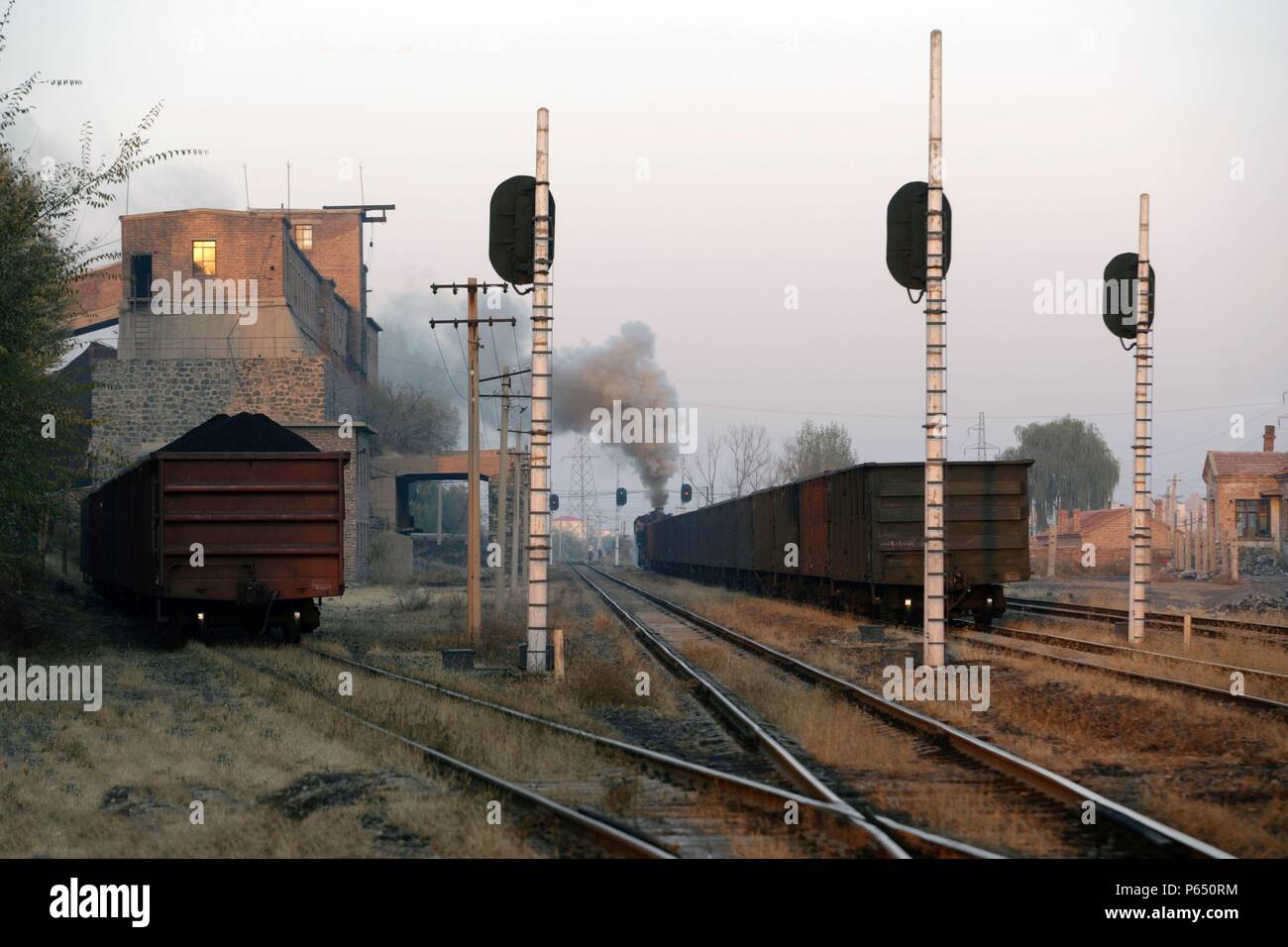 A Chinese SY class 2-8-2 arrives at colliery No 2 with a rake of empty ...