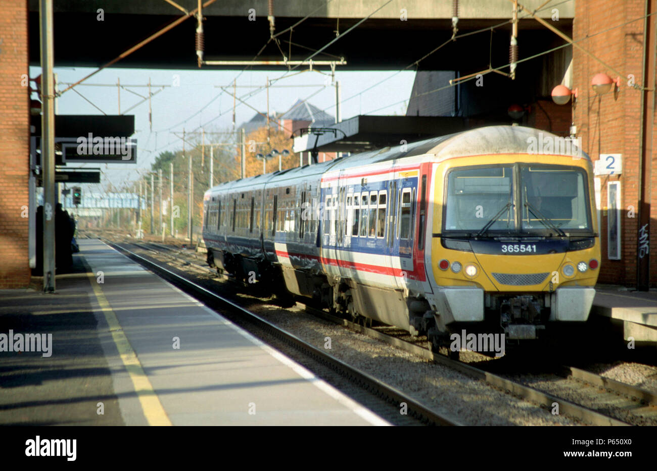 A class 365 train passes through Hitchin station heading south towards ...