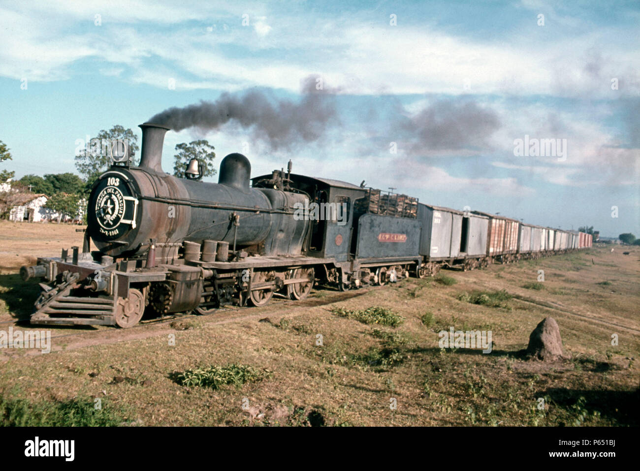 A mixed freight heads away from San Salvador behind an Edwardian styled ...