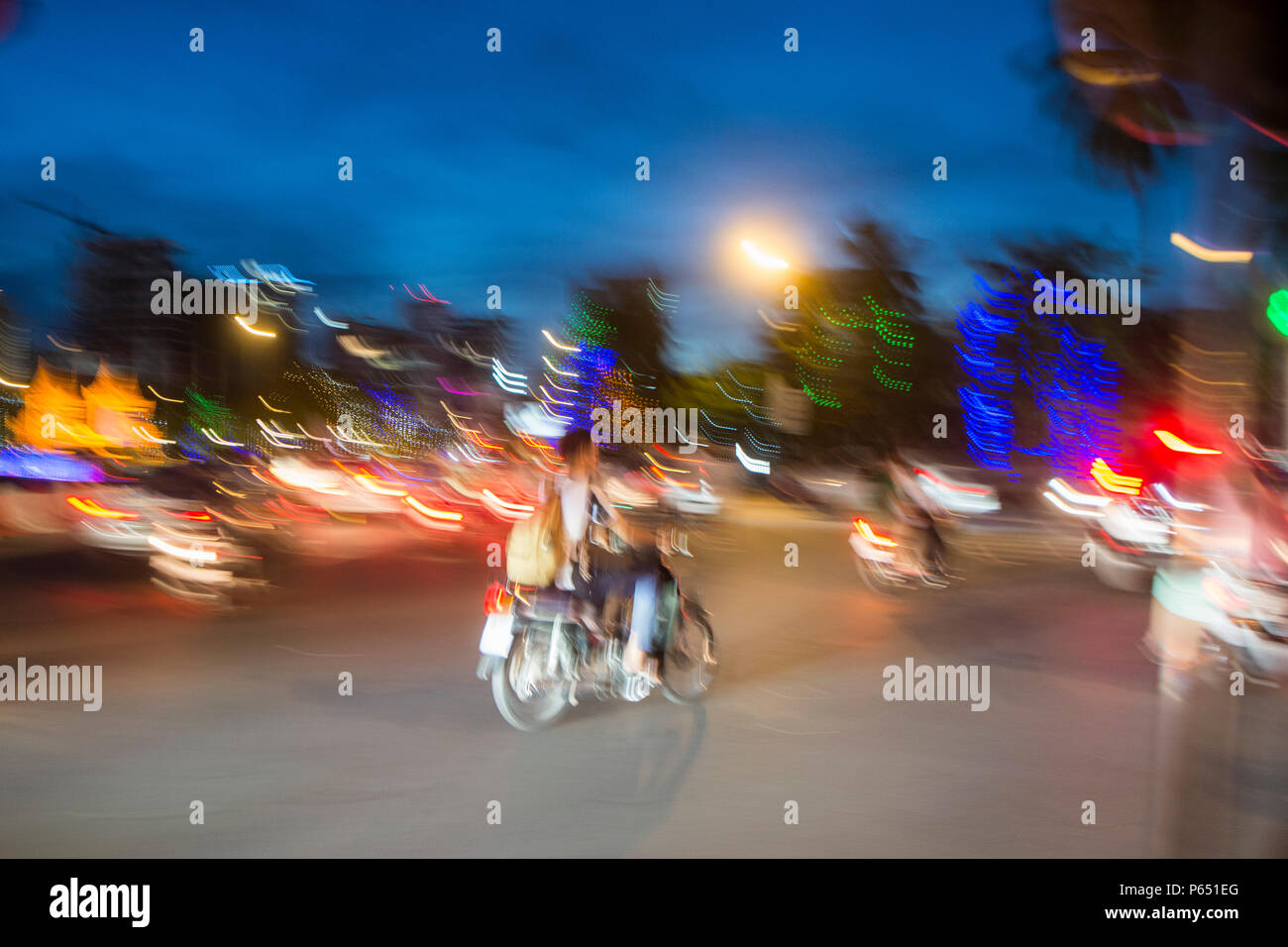 traffic at a street corner in the city of Phnom Penh of Cambodia ...