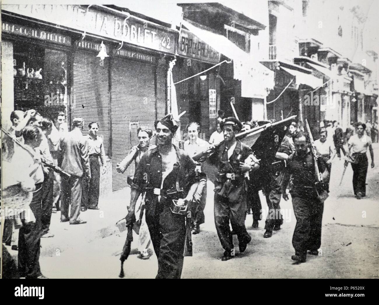 Enthusiastic republican fighters carry a captured flag during the ...
