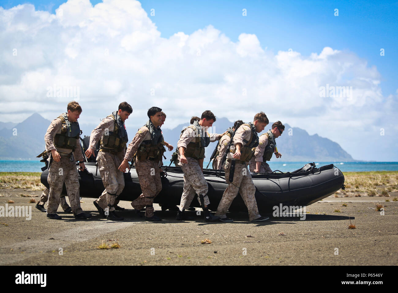 U.S. Reconnaissance Marines carry a combat rubber raiding craft prior ...