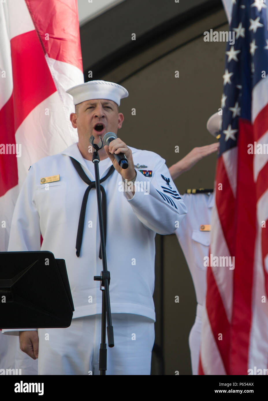 A member of the Navy band sings the national anthem during the Fleet ...