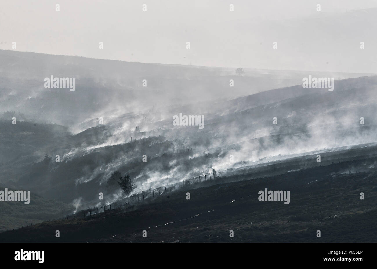 Smoke rises from the fire on Saddleworth Moor, which continues to burn ...