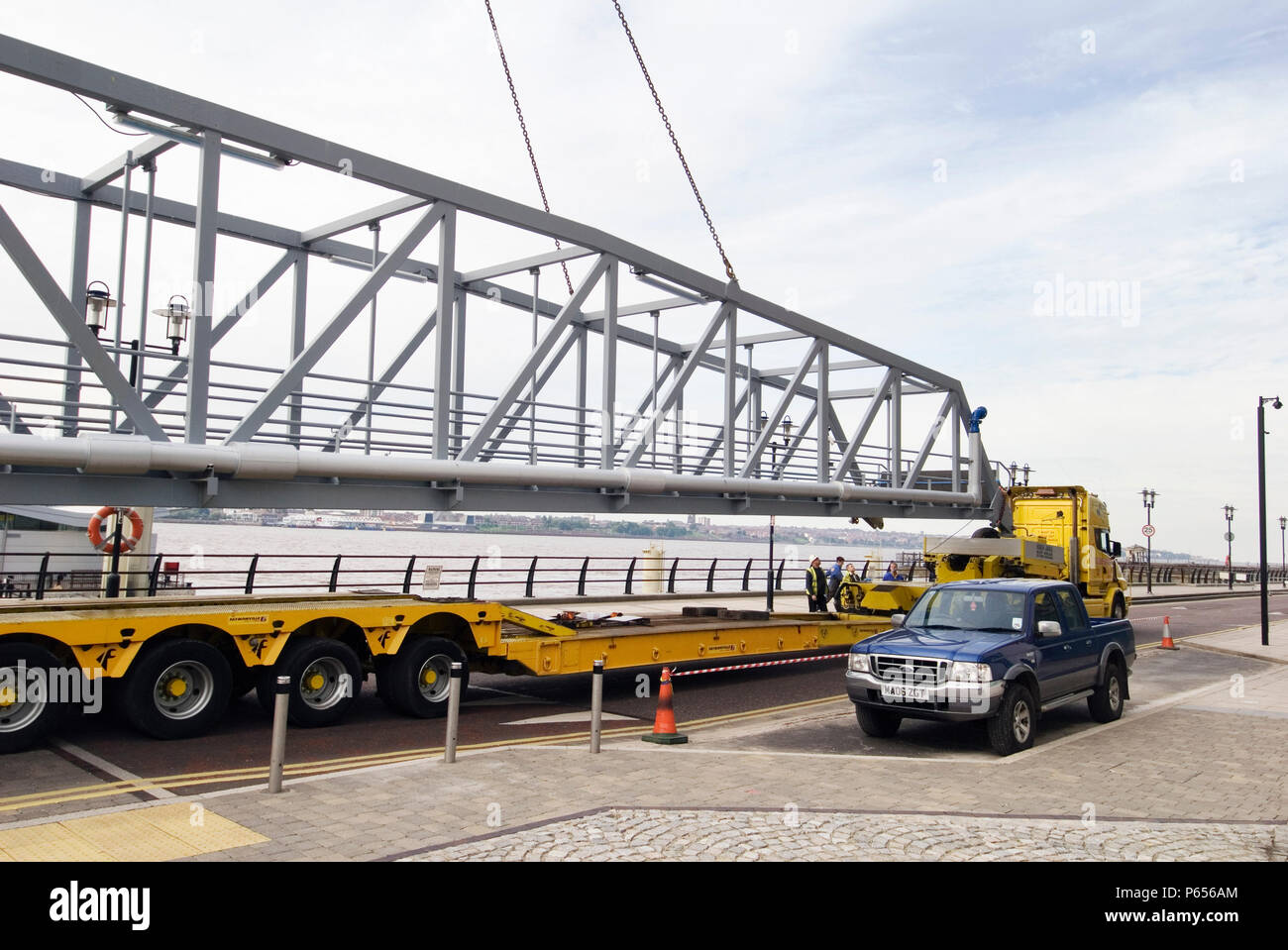 Passenger bridge being lifted onto low loader truck, Liverpool docks ...