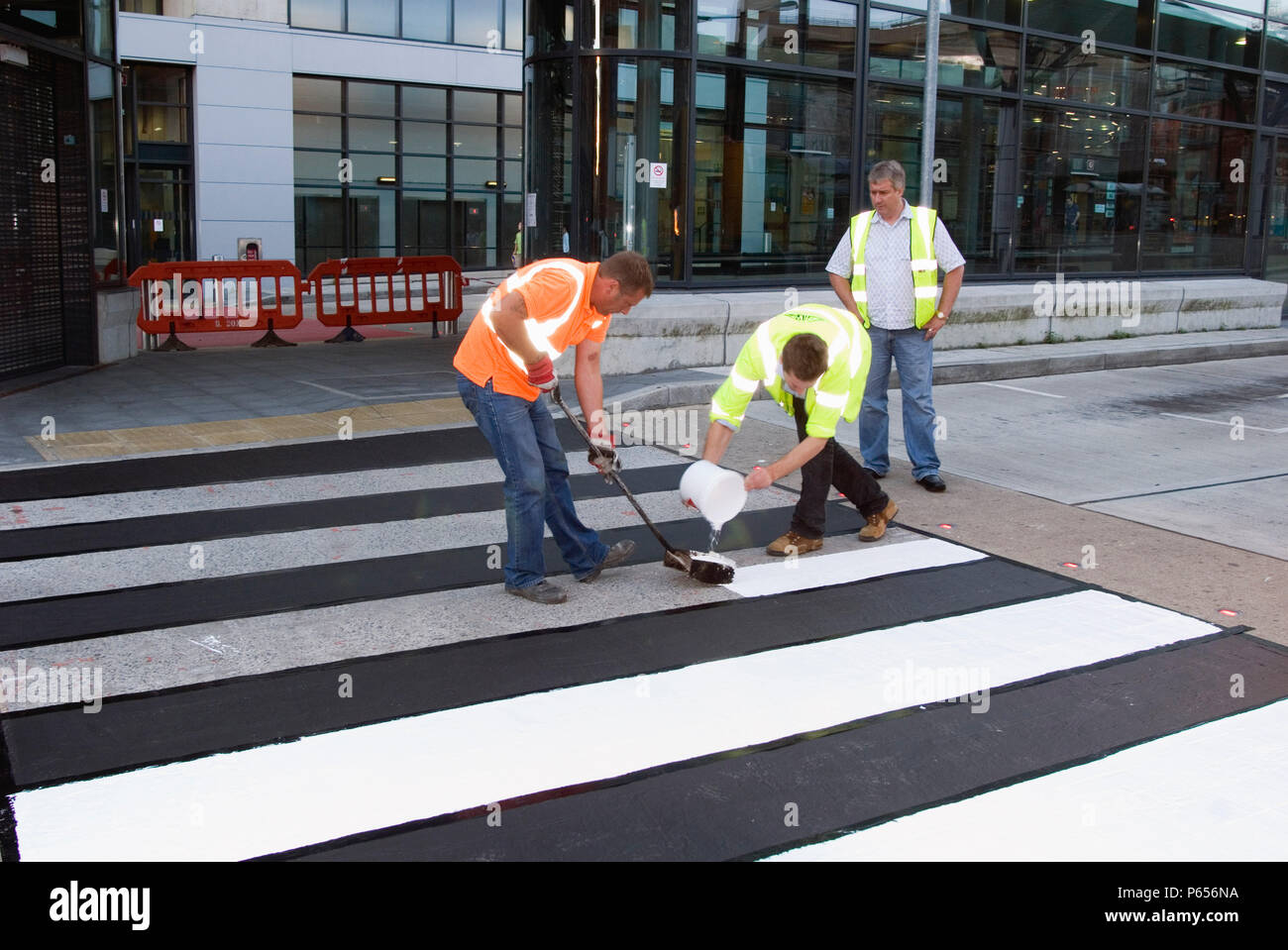 Workmen pouring paint onto new pedestrian crossing, Shudehill ...