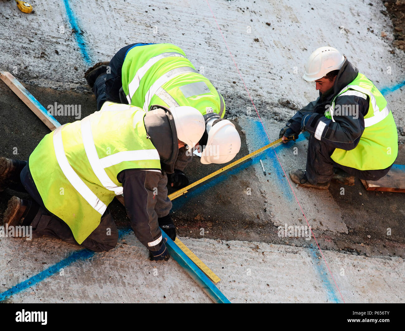 Construction workers marking floor Stock Photo - Alamy