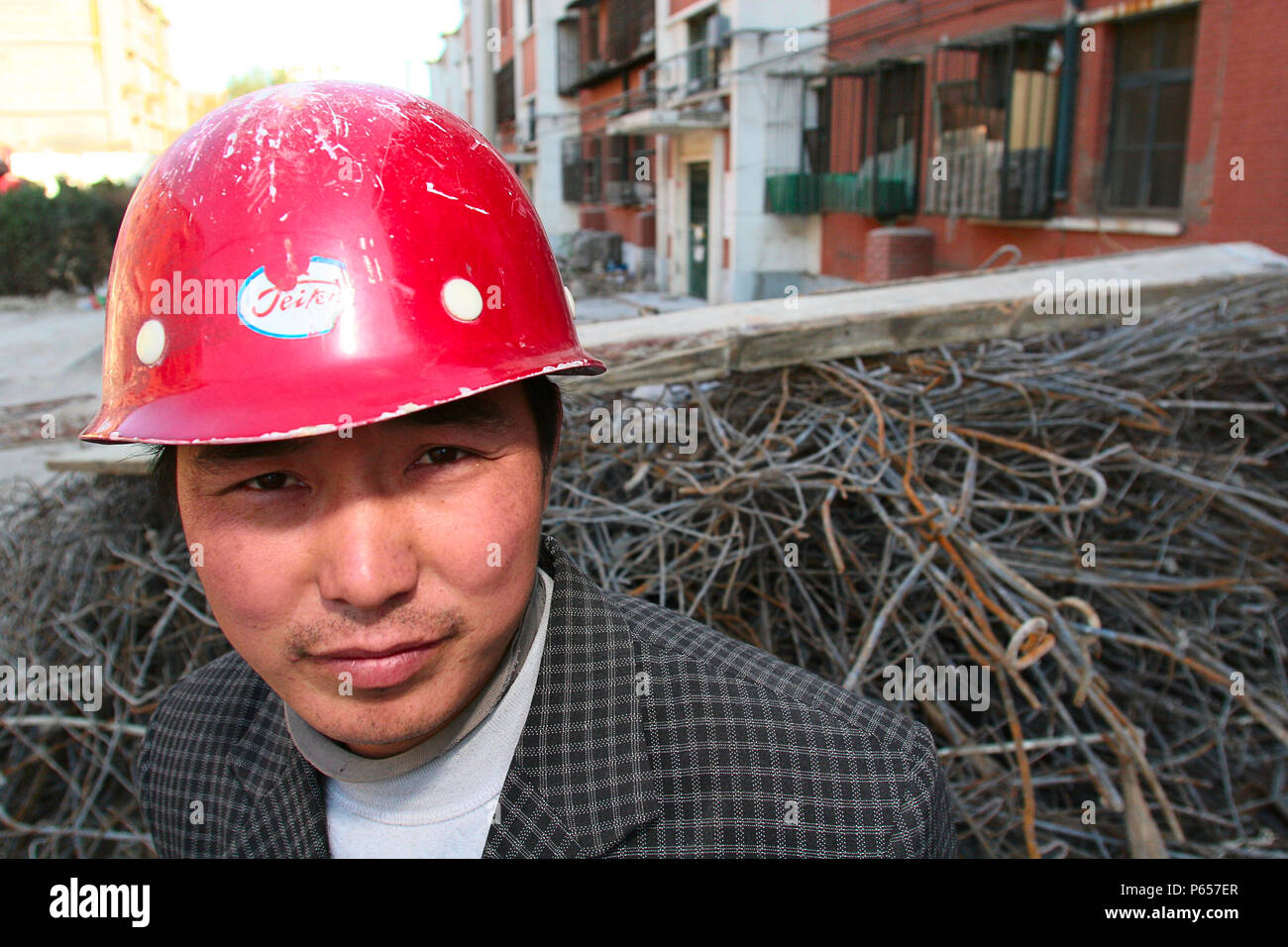 A Chinese foreman supervising the demolition of residential housing in ...
