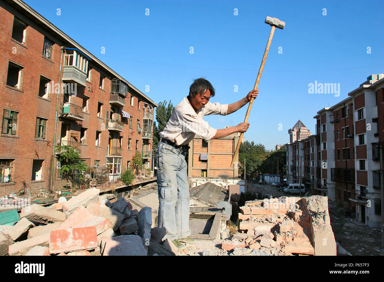 A Chinese migrant labourer working on the demolition of residential ...