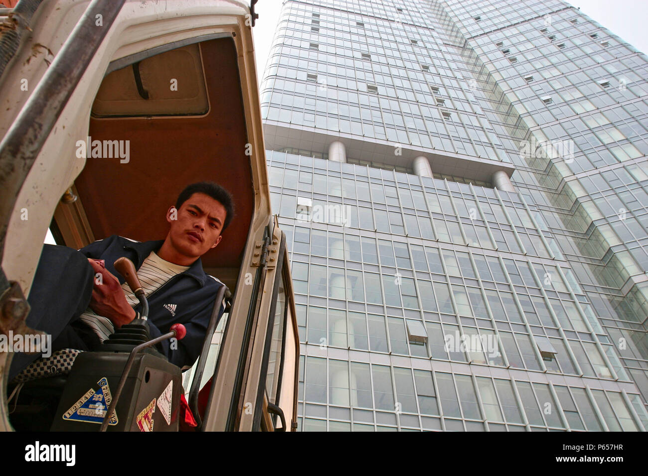 A digger driver outside Fortune Plaza in central Beijing Stock Photo ...