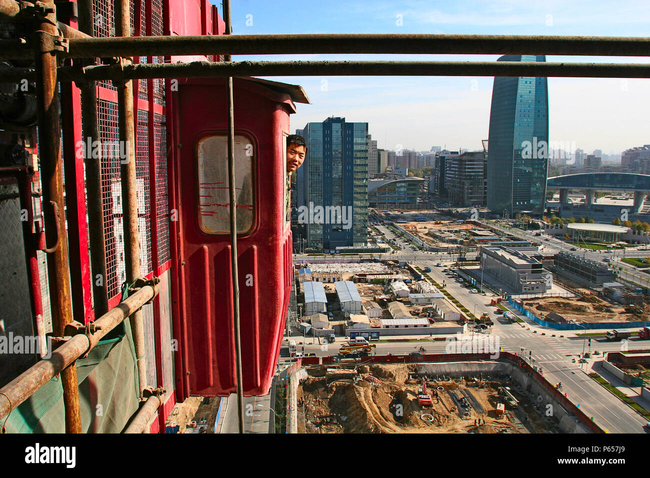 A lift operator looks out from the lift compartment on a building in ...