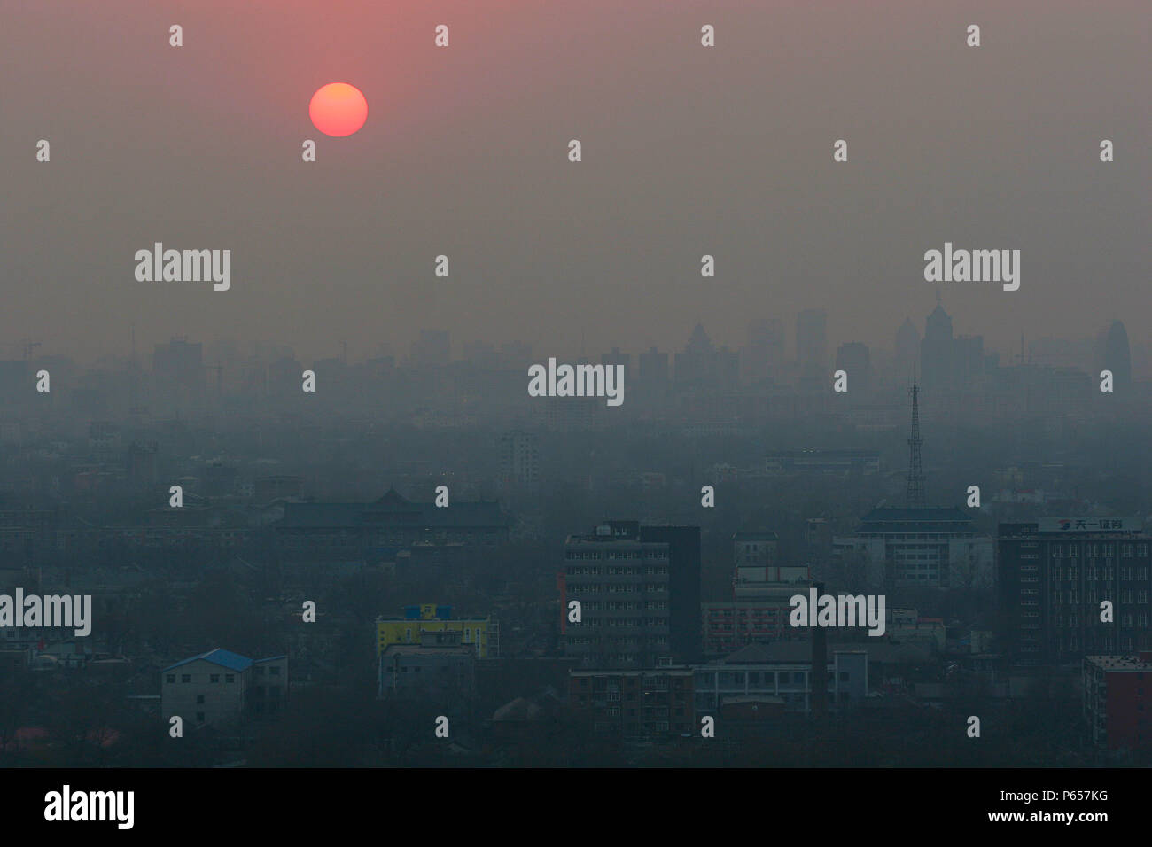 A sunset through a pollution haze in Beijing Stock Photo - Alamy