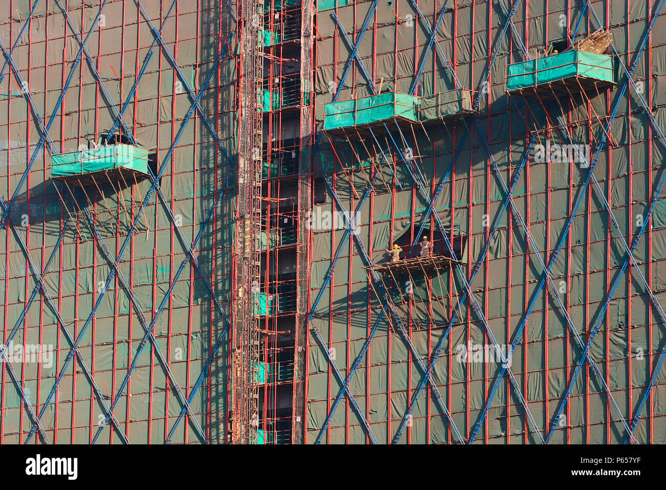 Workers prepare used wooden struts for lifting by crane on the Facade ...