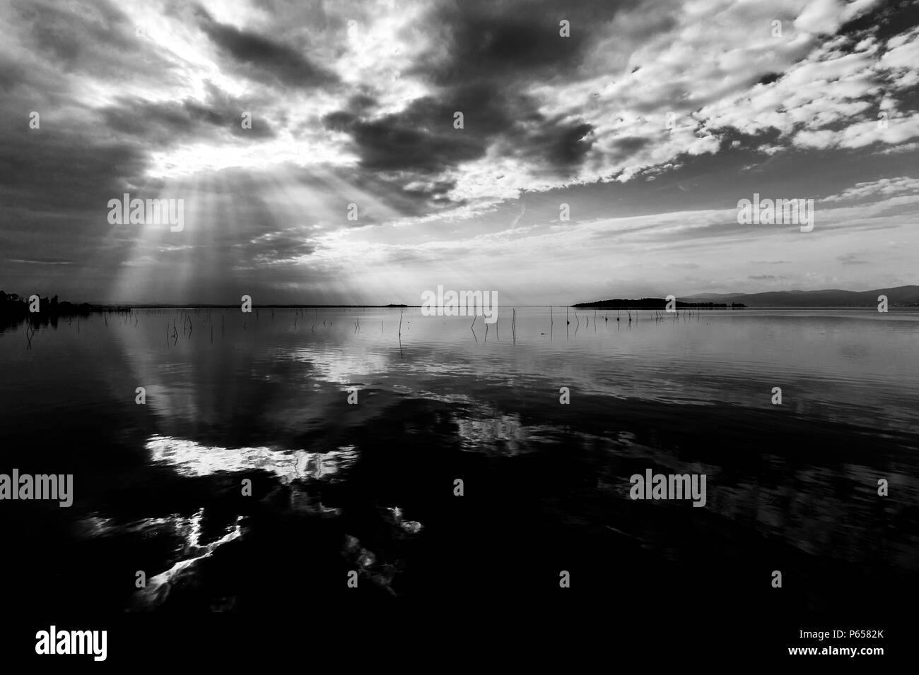 Perfectly symmetric and spectacular view of a lake, with clouds, sky ...