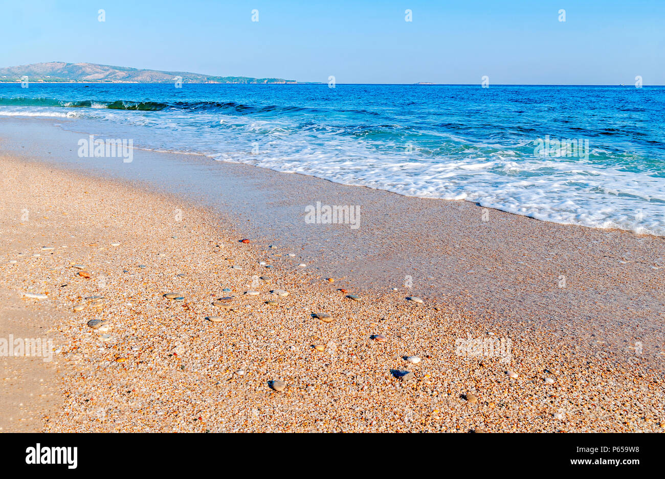 Sand beach and wave in Greece Stock Photo - Alamy
