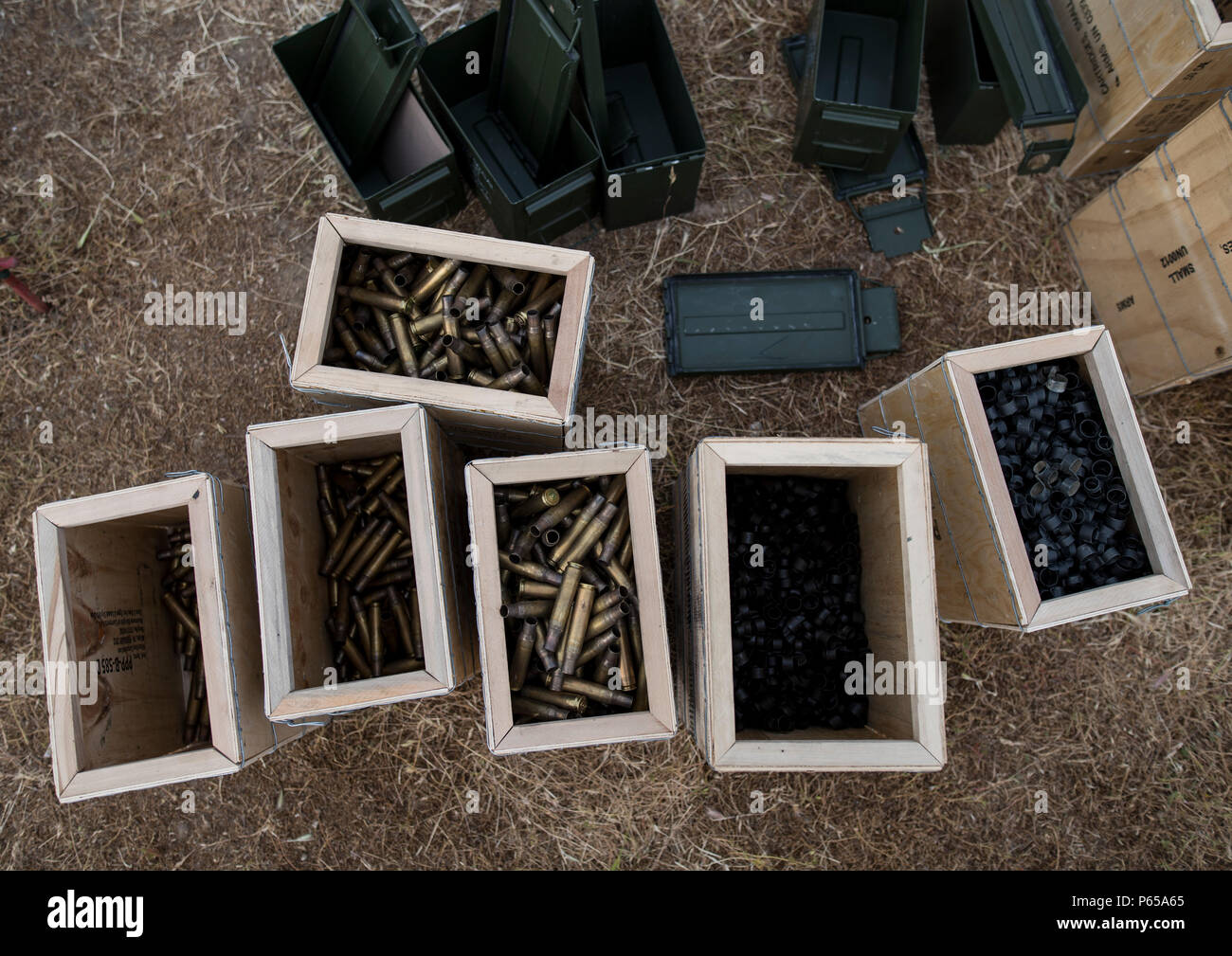 Expended brass shells and discarded clips are collected into various ...