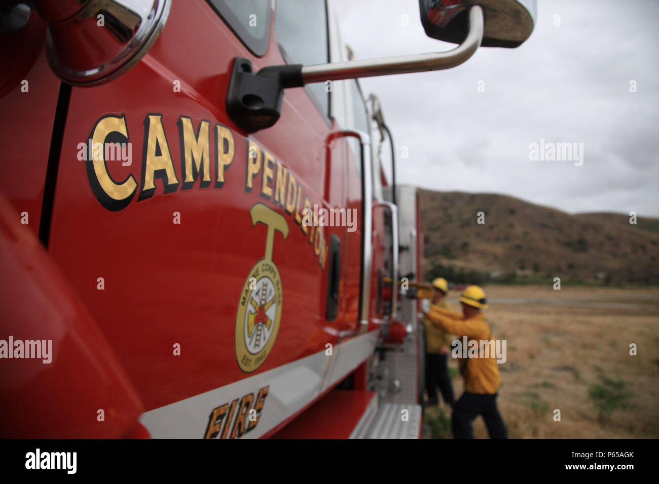Firefighters from the Camp Pendleton Fire Department pack the firetruck up after participating ...