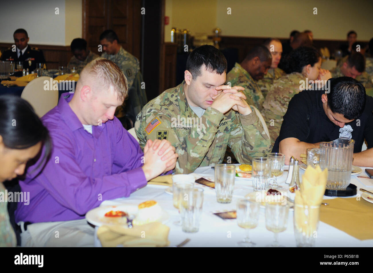 Participants pray during the national prayer breakfast April 28 at the ...