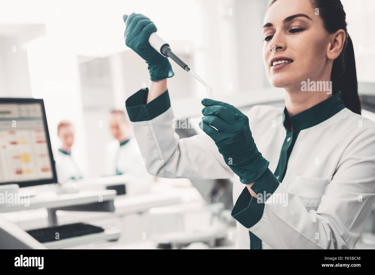 Portrait of concentrated laboratory assistant taking analyses with ...