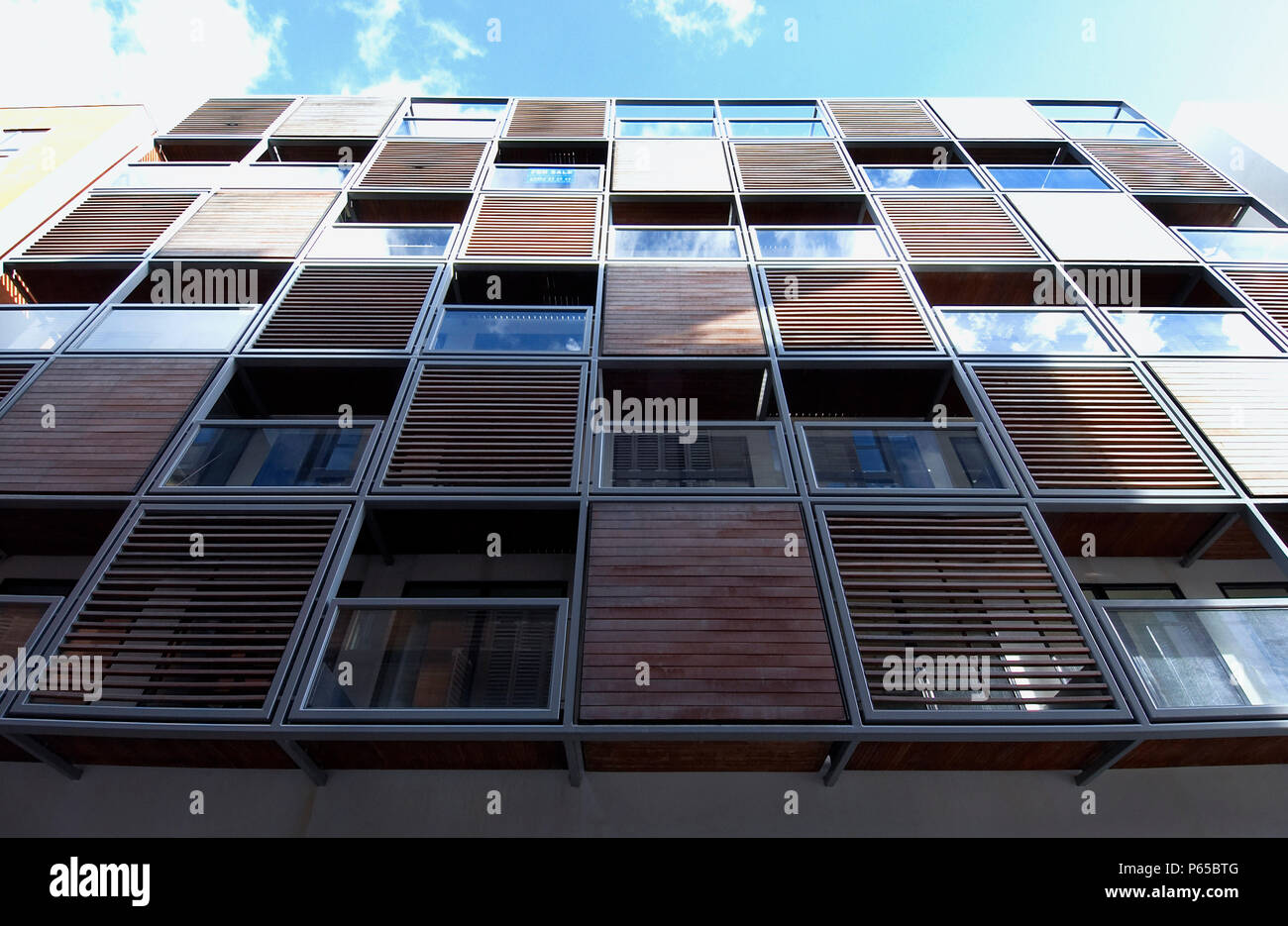 Residential development with wood shutters and timber cladding ...