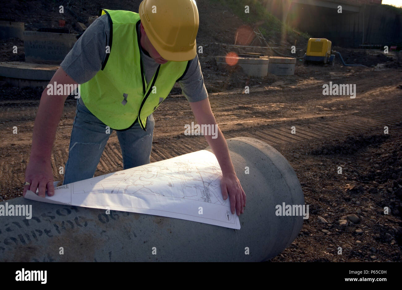 Building technician checking plan on site Stock Photo - Alamy